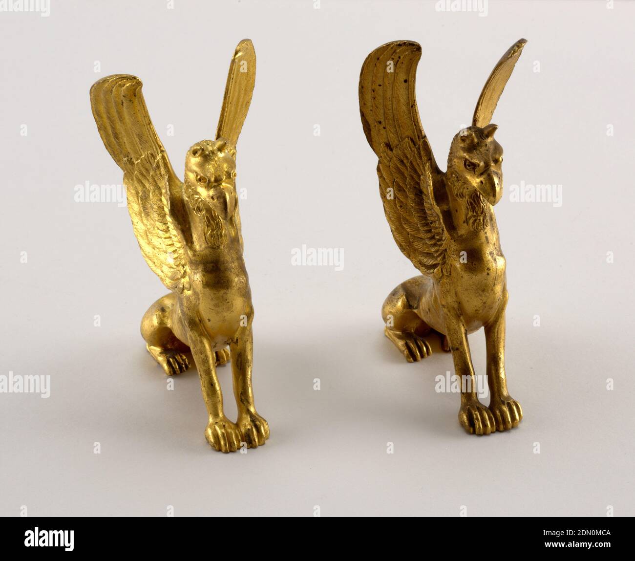 Griffons, Gilt bronze, Pair of seated griffons with outstretched paws ...