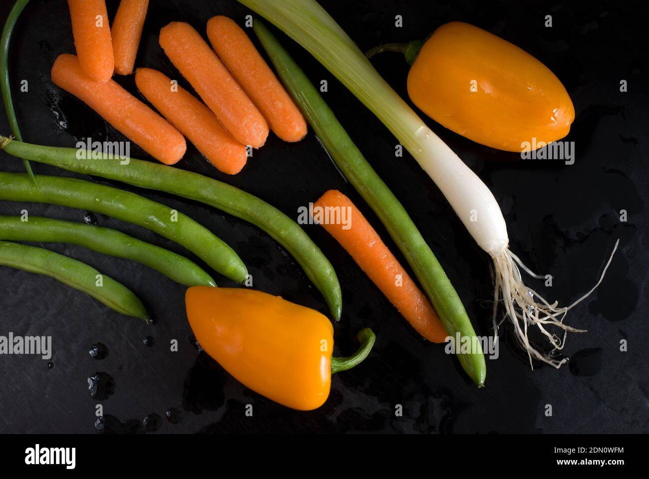 Beautiful Colorful Fresh Yellow and Green Vegetables on a Wet Black ...
