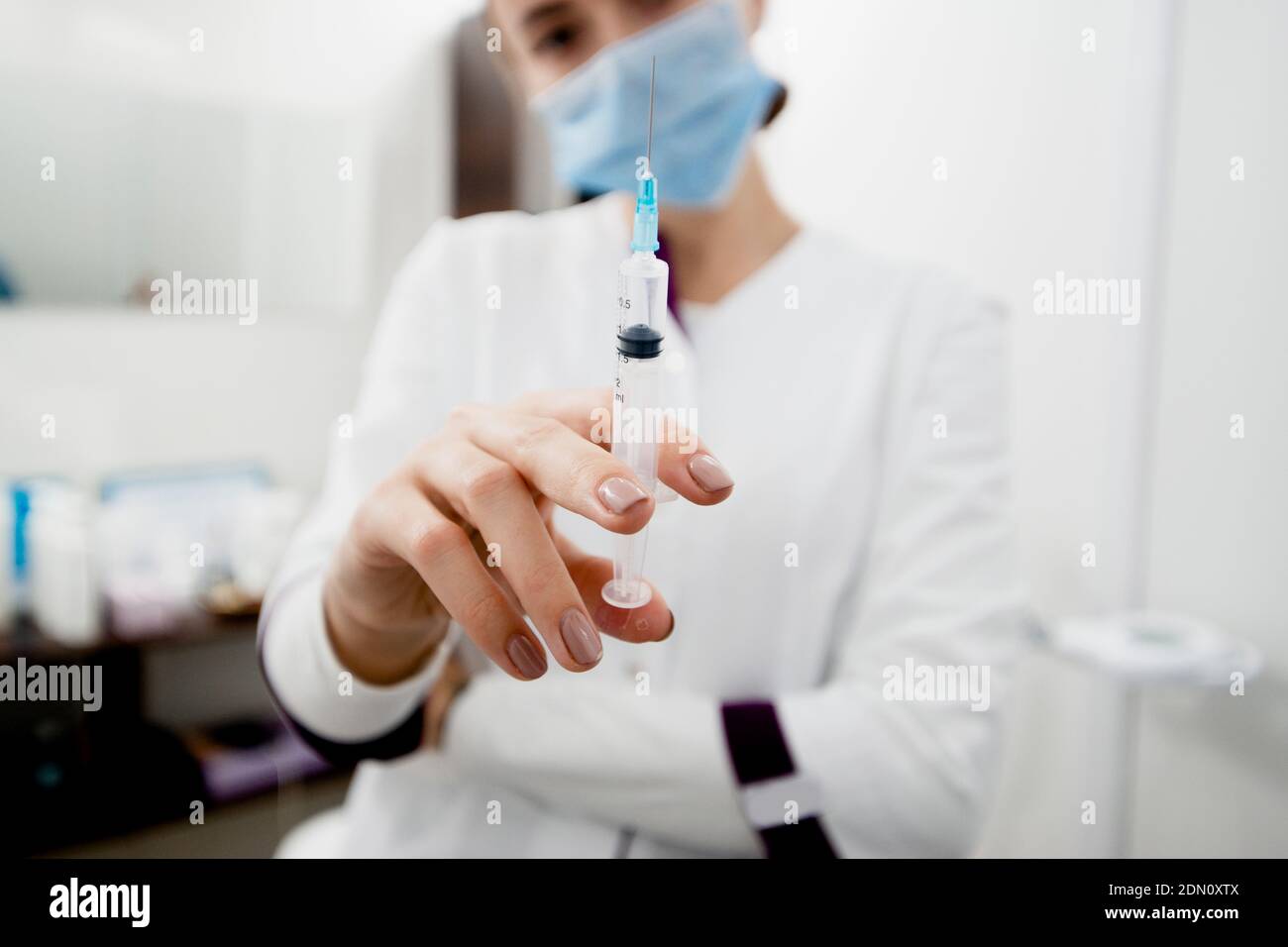 Young white doctor with syringe is ready to make injection Stock Photo ...