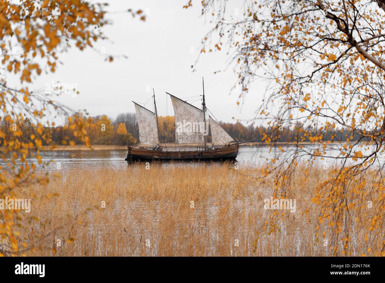 Wooden old ship in vintage style with all sails set in misty lake ...