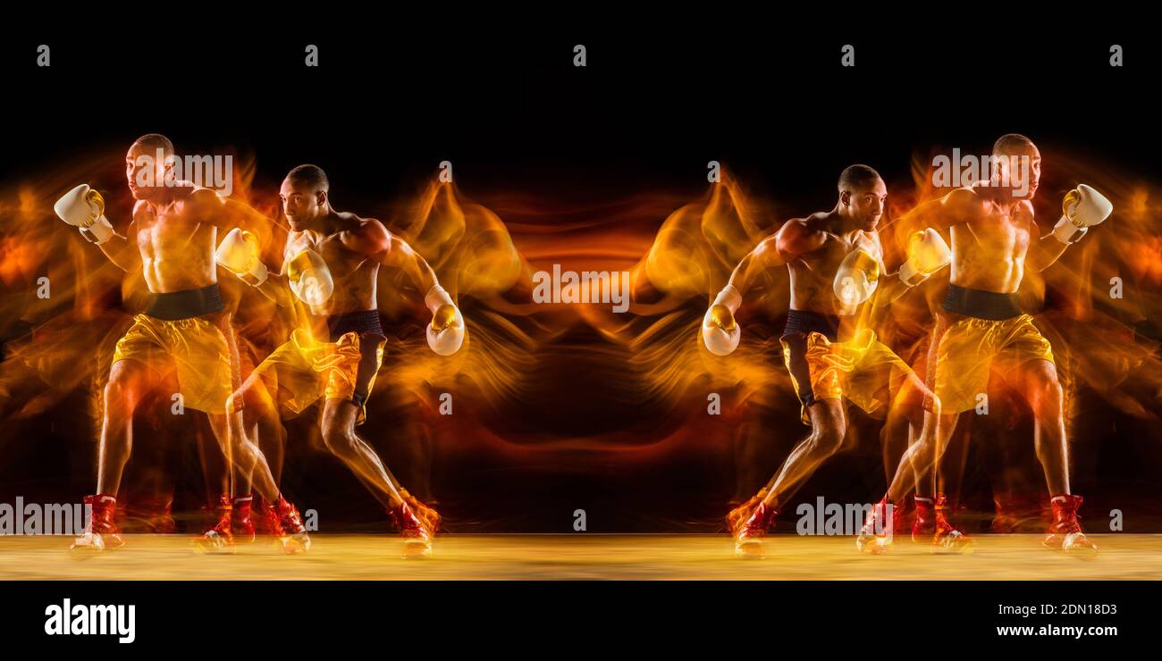 Professional african-american boxer training on black studio background ...