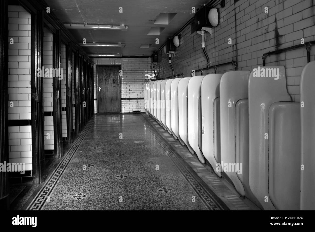 Black and white perspective view of empty gentlemen public restroom ...