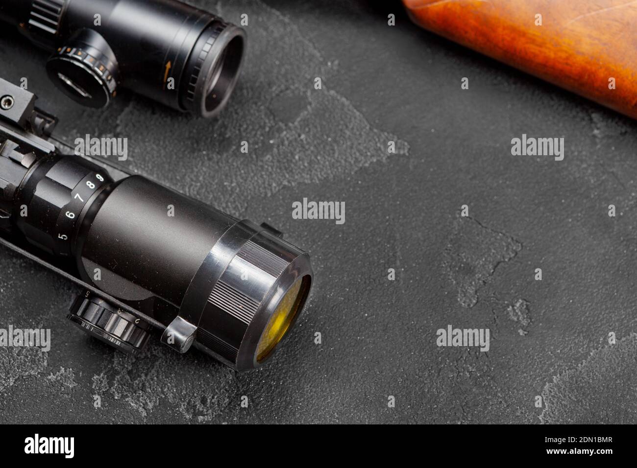 Optical sight of hunting rifle on grey background Stock Photo - Alamy