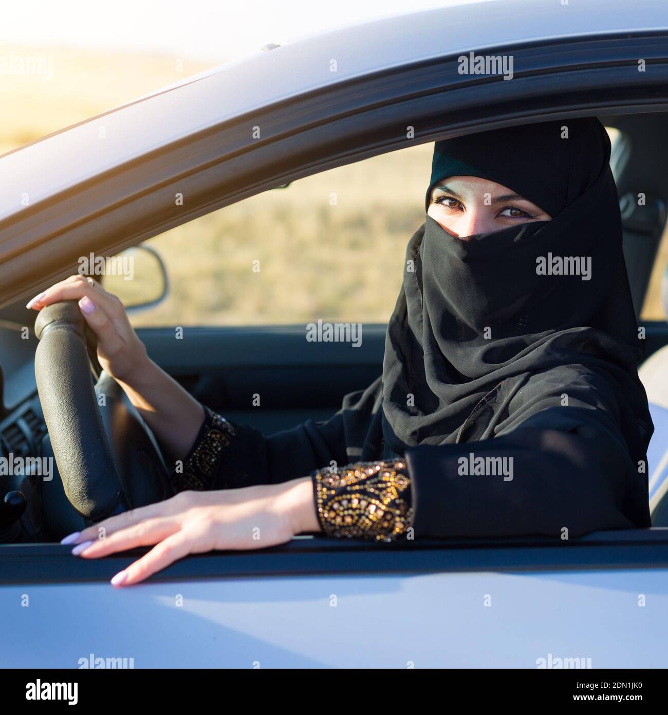 Islamic woman driver in traditional black clothes Stock Photo - Alamy