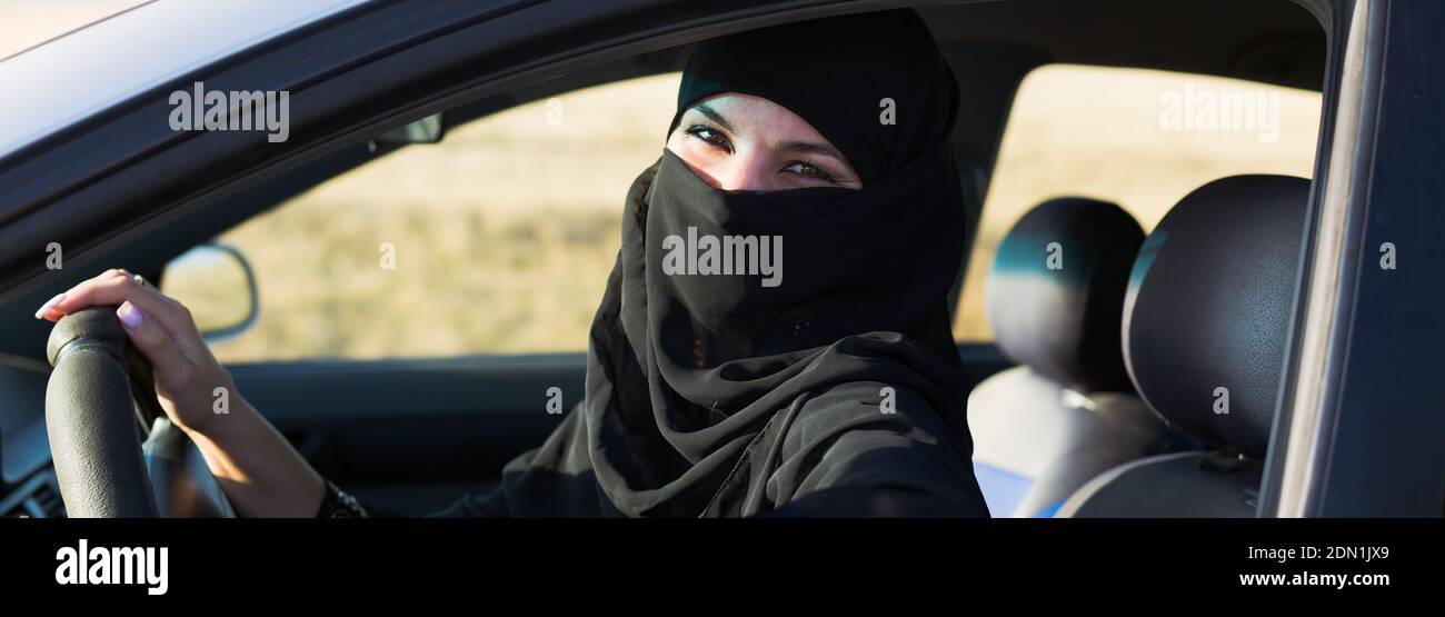 Islamic woman driver in traditional black clothes Stock Photo - Alamy