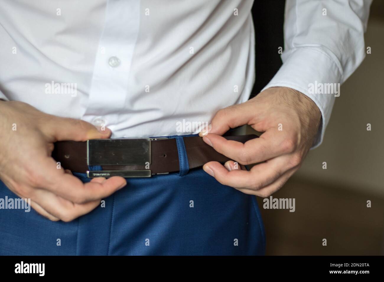 Man adjusting belt hi-res stock photography and images - Alamy