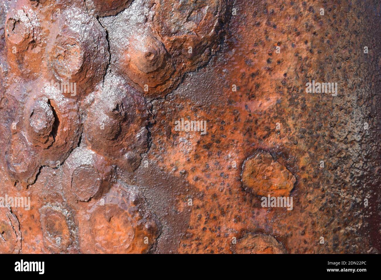 Close-up of rusted metal harbor mooring post with barnacles, pitted ...