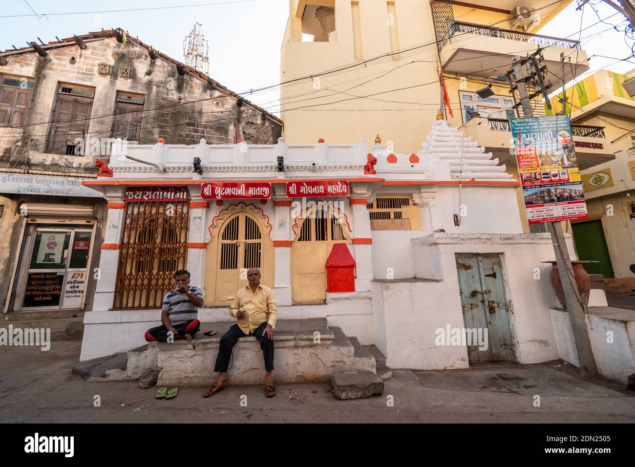 Jamnagar, Gujarat, India - December 2018: Two men sitting outside an ...