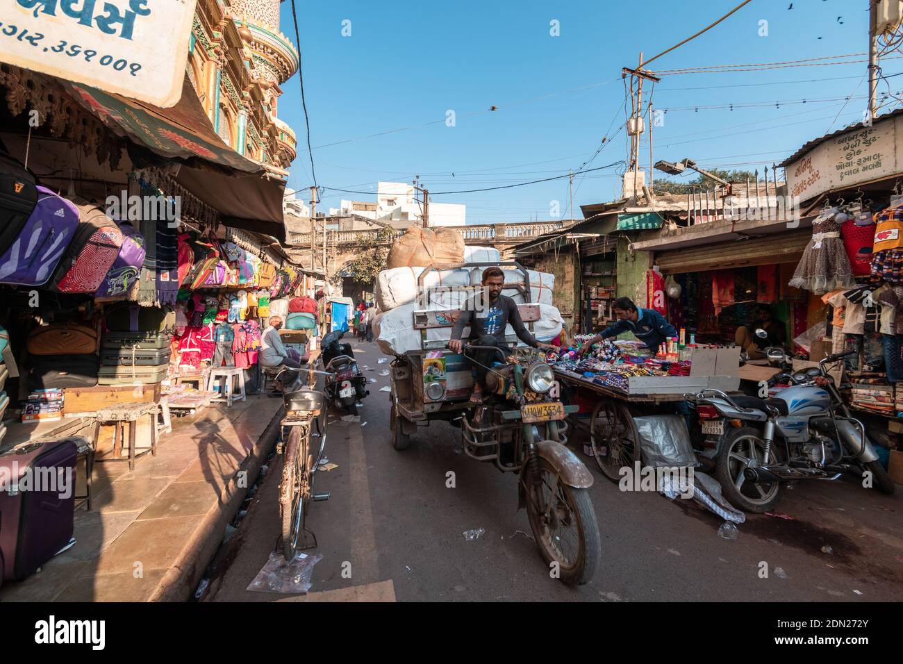 Jamnagar, Gujarat, India - December 2018: An Indian man transporting ...