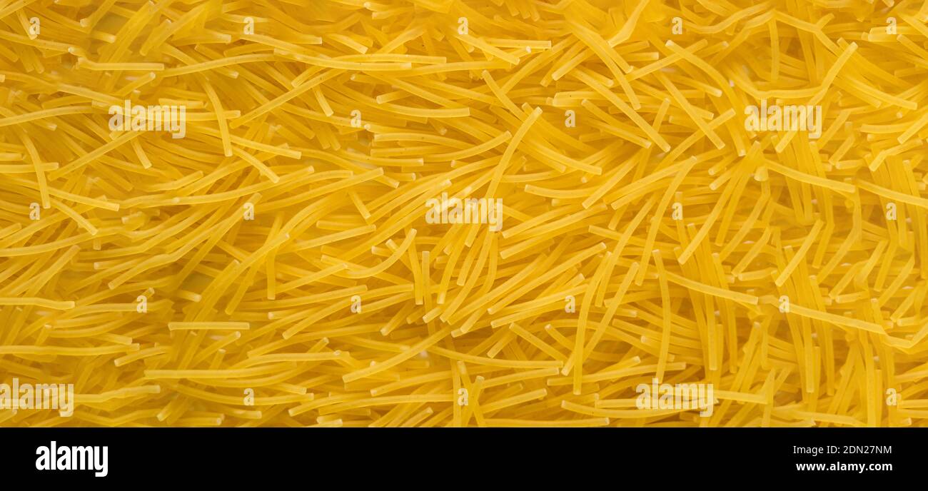 short thin vermicelli on the whole background. texture of dry yellow ...