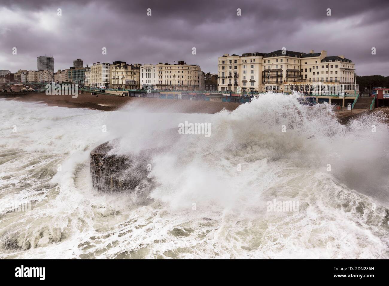 big waves breaking on Brighton seafront Stock Photo - Alamy