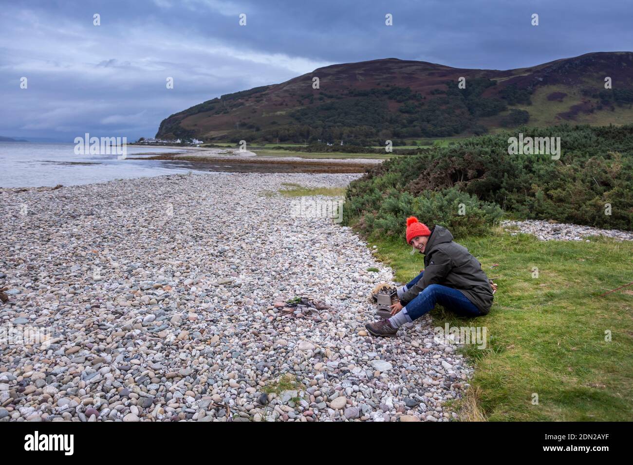 sitting making a fire by the sae on Arran Stock Photo - Alamy