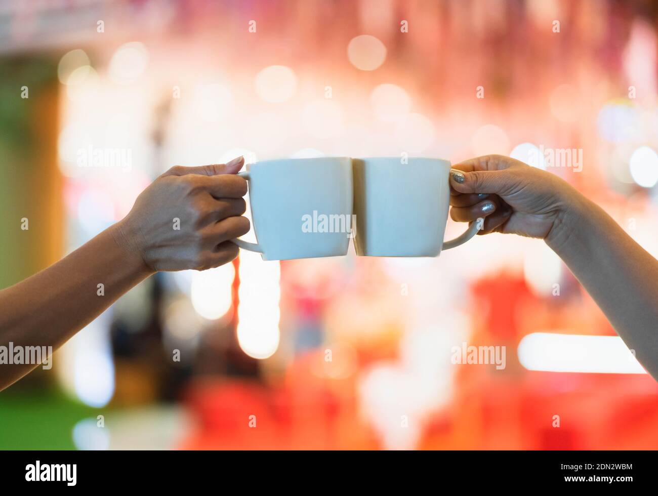 Hands toasting cups High Resolution Stock Photography and Images - Alamy