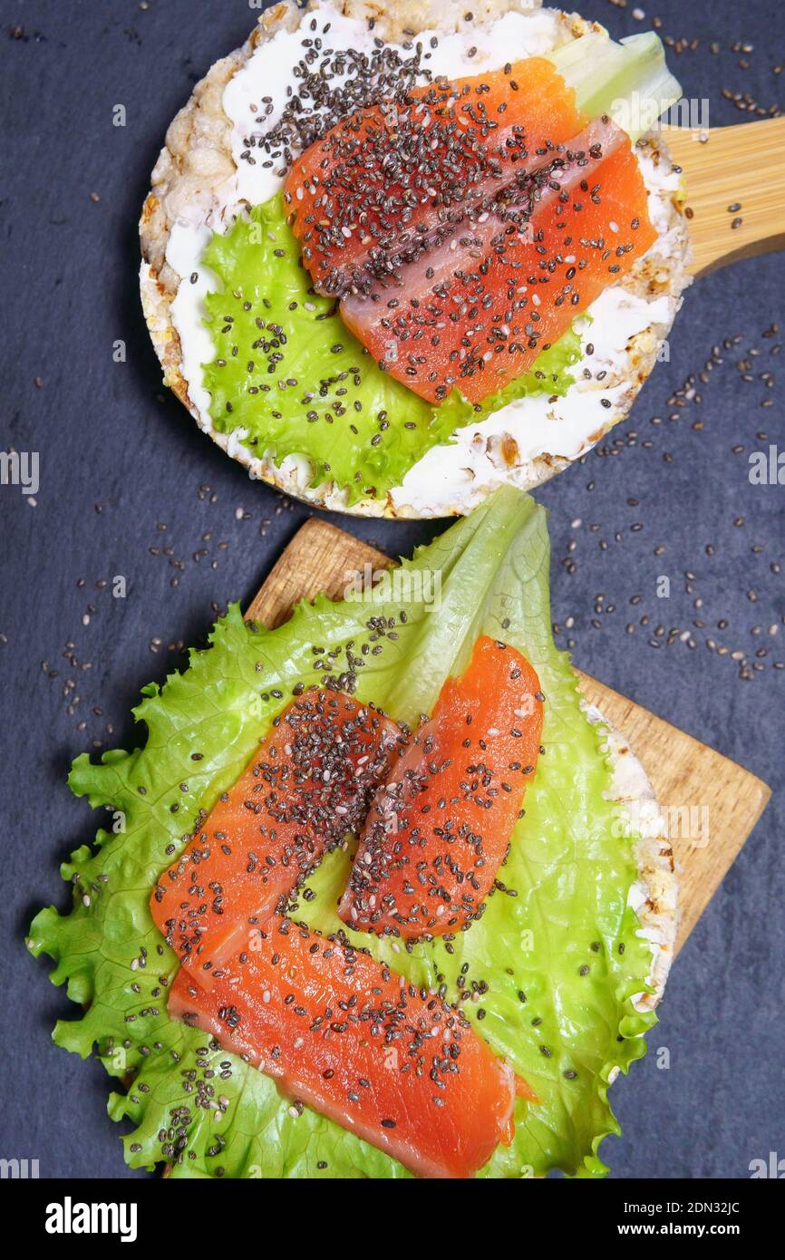 Healthy lunch of crispbread with salmon, lettuce and cream cheese. flat ...