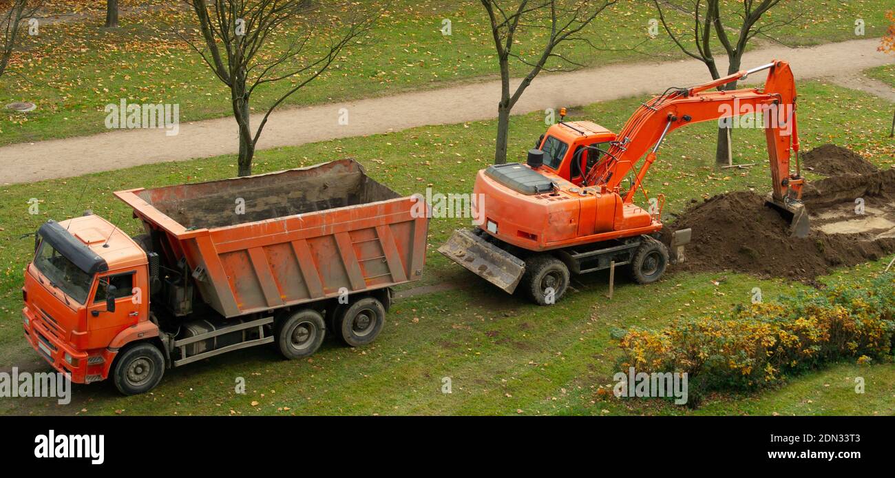 excavator and dump truck. work on the arrangement of tracks Stock Photo ...