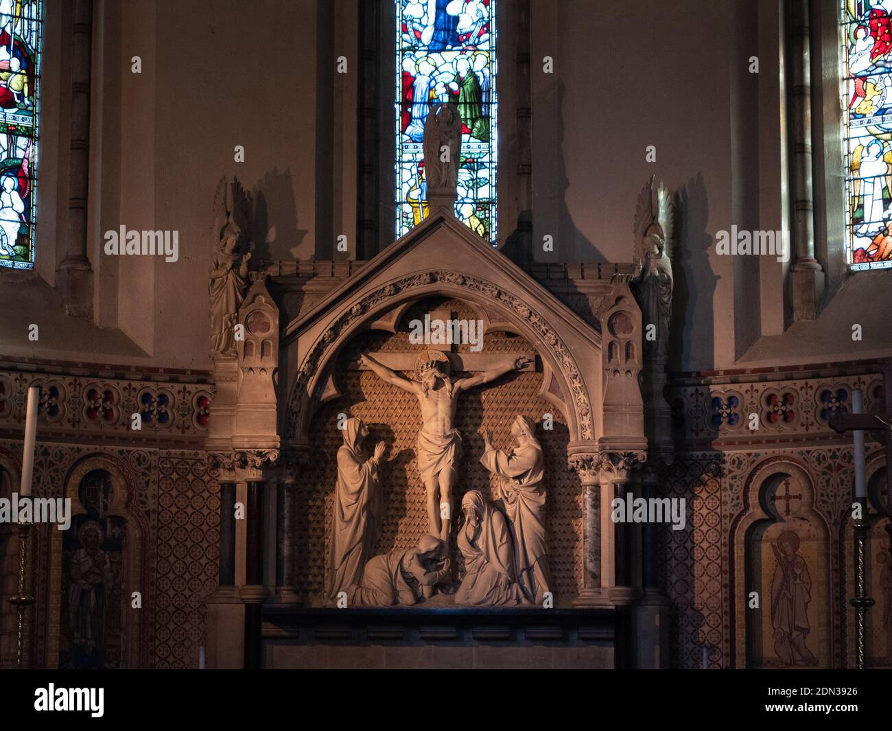 Stone reredos with Crucifixion scene below aedicule in east end apsidal ...
