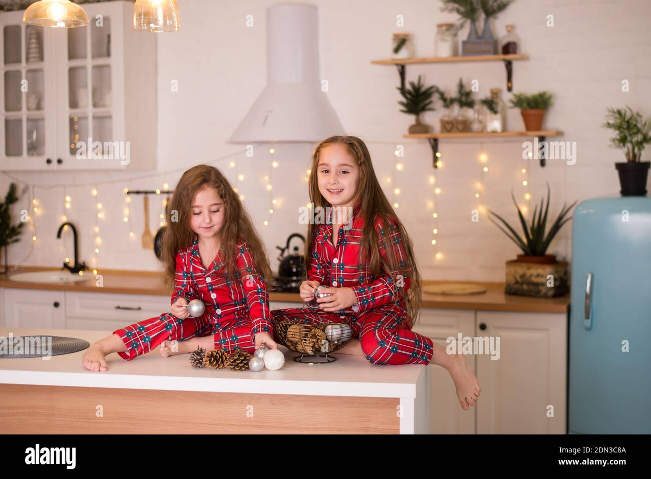 the day with gifts and Christmas tree two girls sisters Stock Photo - Alamy