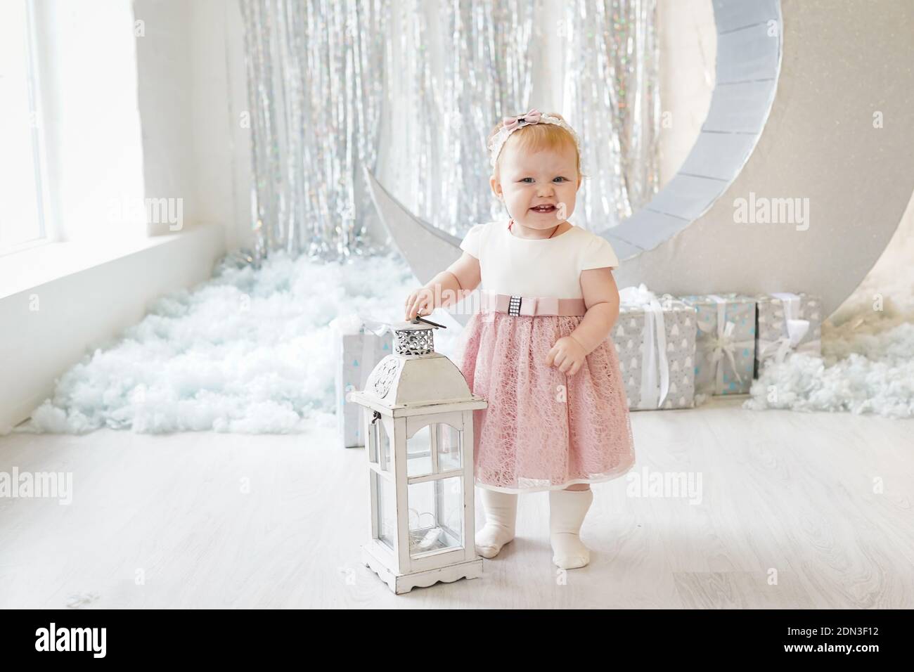 LIttle cute girl in very beautiful pink dress and bow standing with ...