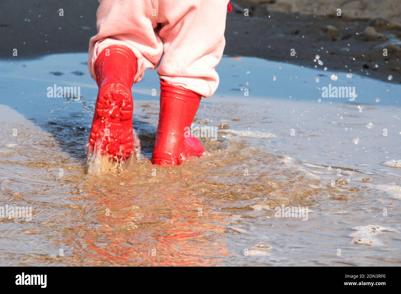 Child in boots stamping hi-res stock photography and images - Alamy