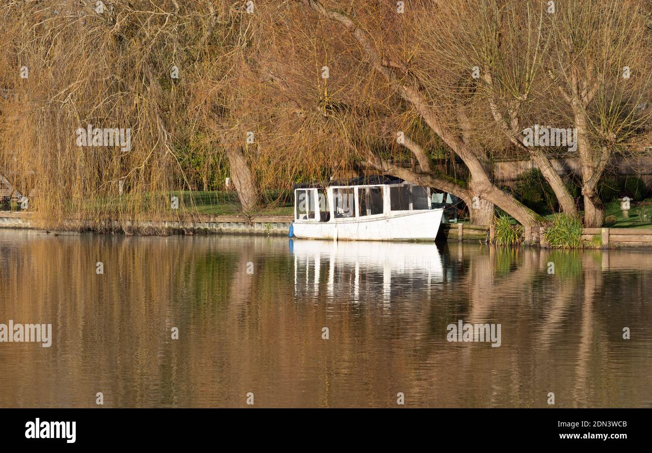 View of boat moored on the bank of the River Thames at Cookham ...