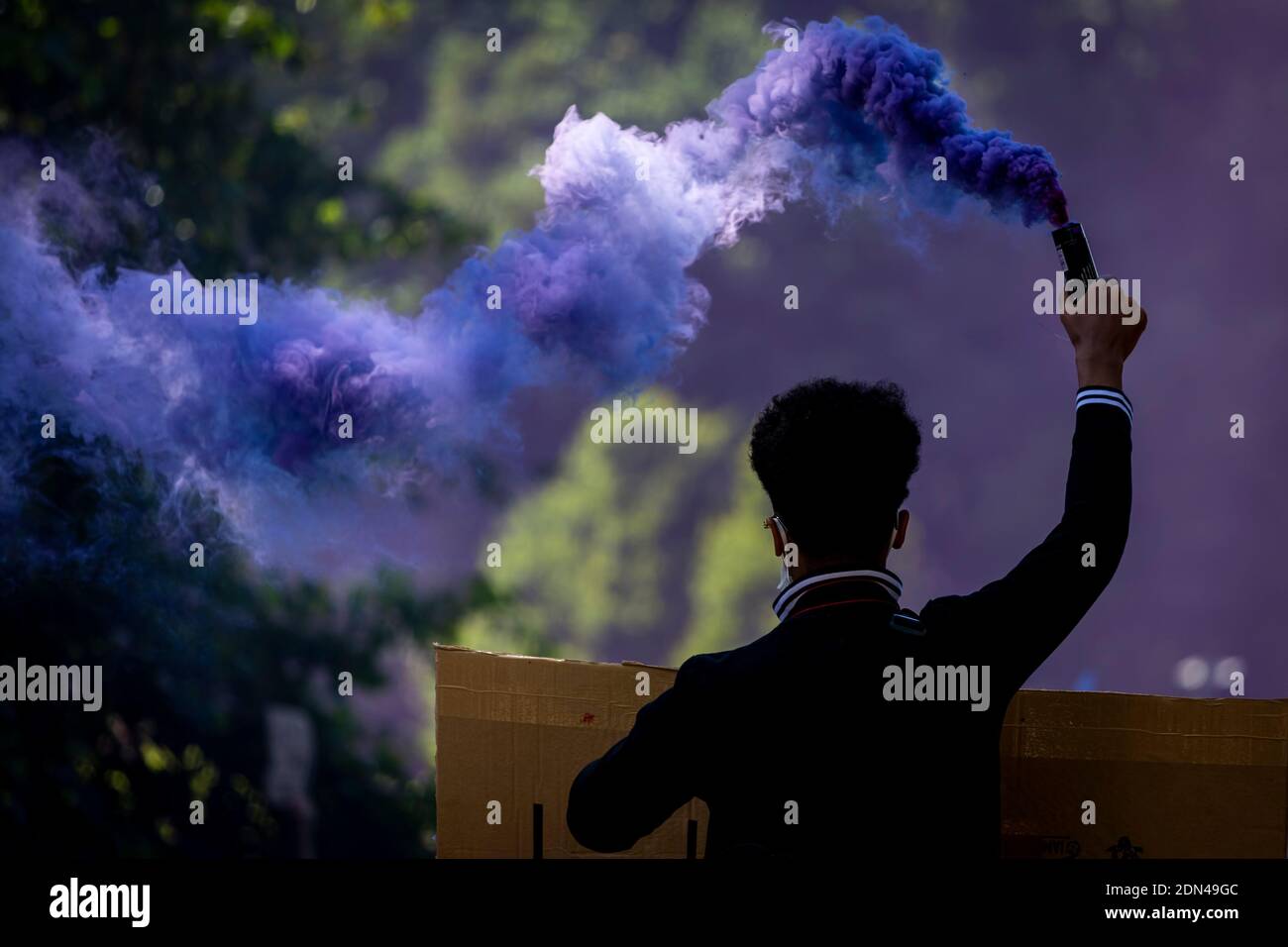 man from behind holding a flare Stock Photo - Alamy