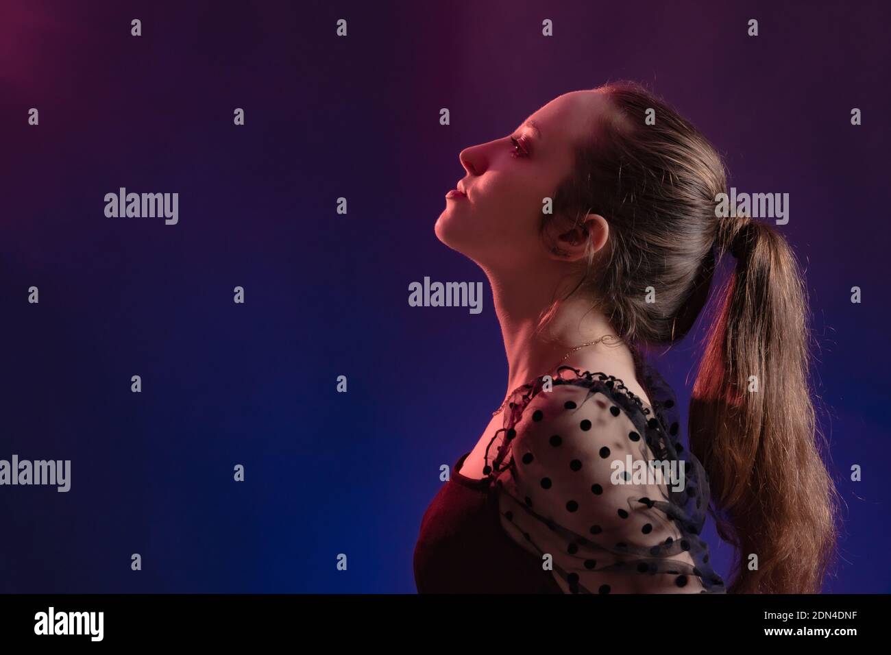 Portrait of an inspired beautiful young girl with color backlight Stock ...