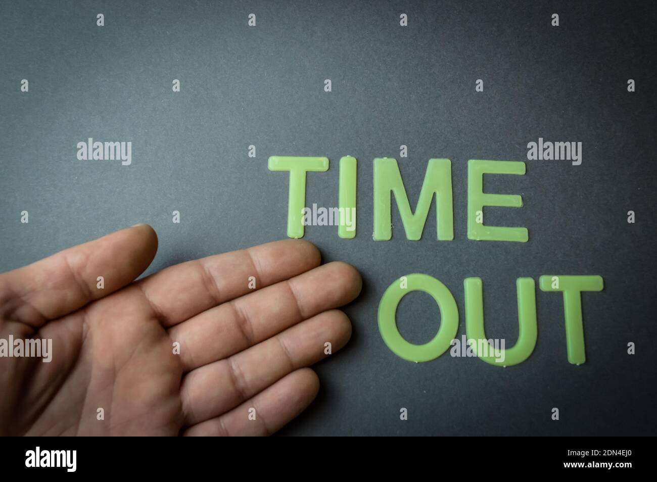 Human hand showing the word Time Out written with plastic letters on ...