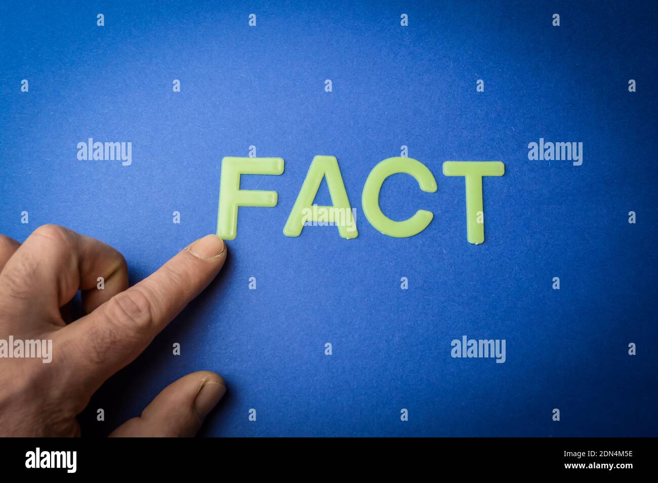 Human finger pointing the word Fact written with plastic letters on ...