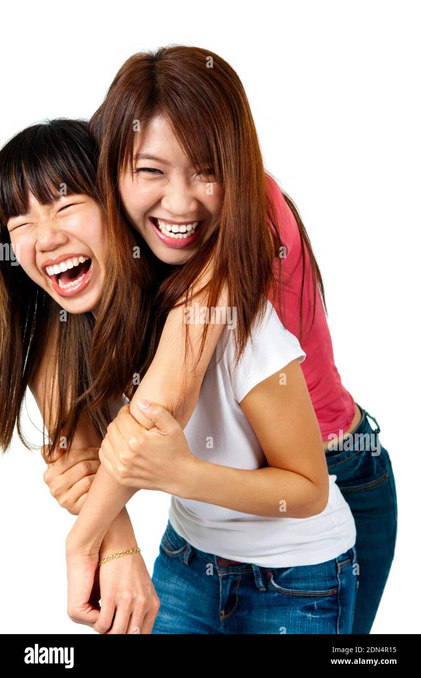 Happy Friends Embracing Against White Background Stock Photo - Alamy
