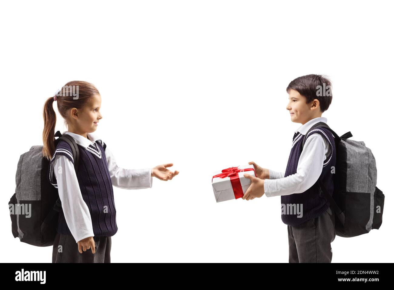 Boy giving present to a schoolgirl isolated on white background Stock ...