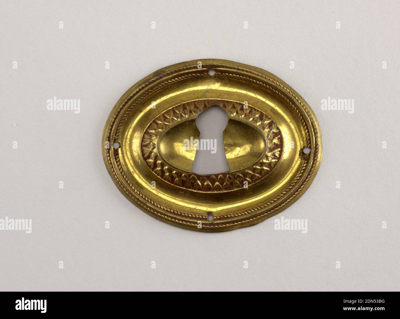Keyhole escutcheon, Brass, Elliptical in shape, horizontal. Repoussé ...