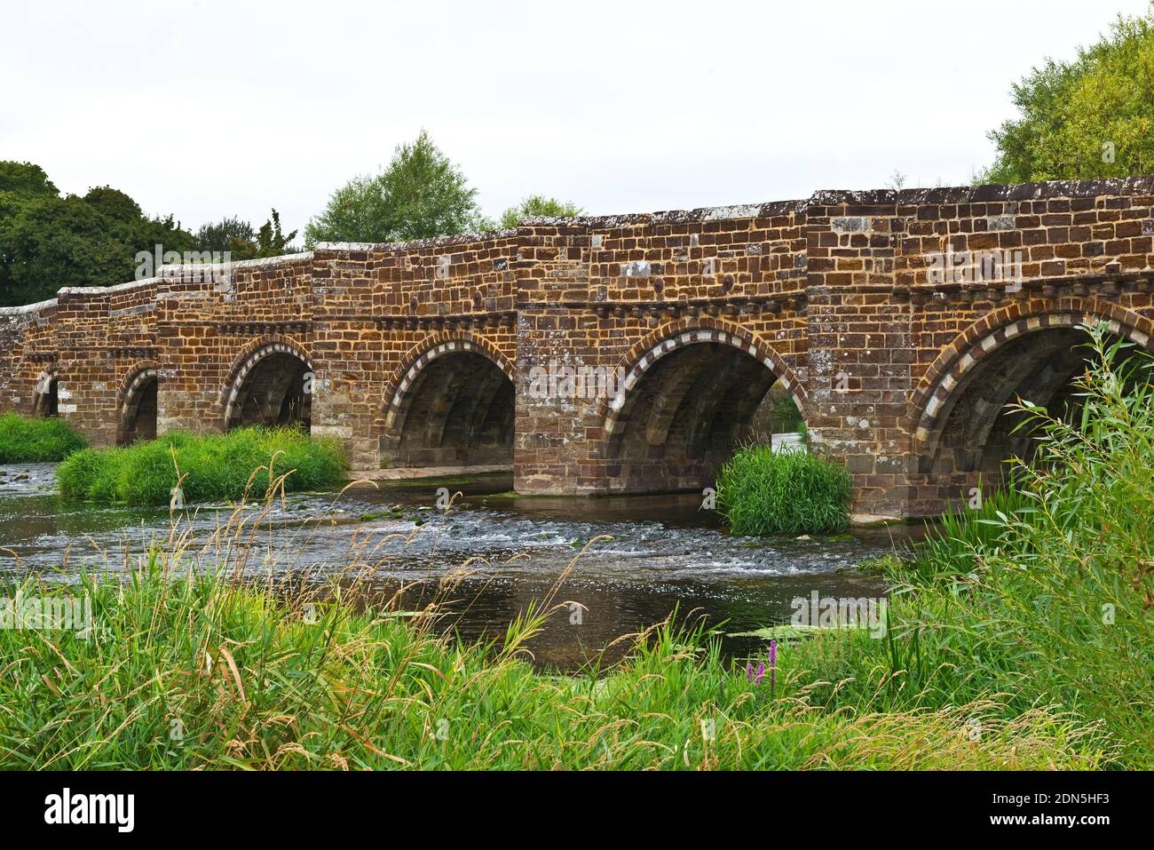 A summertime picture of the eight arched, Medieval, White Mill bridge ...