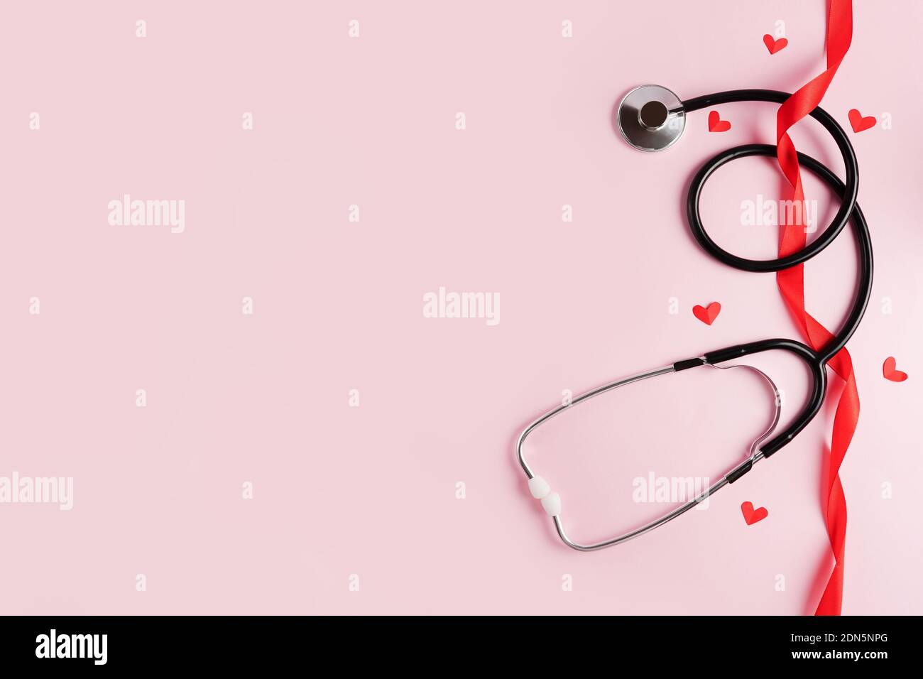 Stethoscope medical equipment with red hearts on pink background ...
