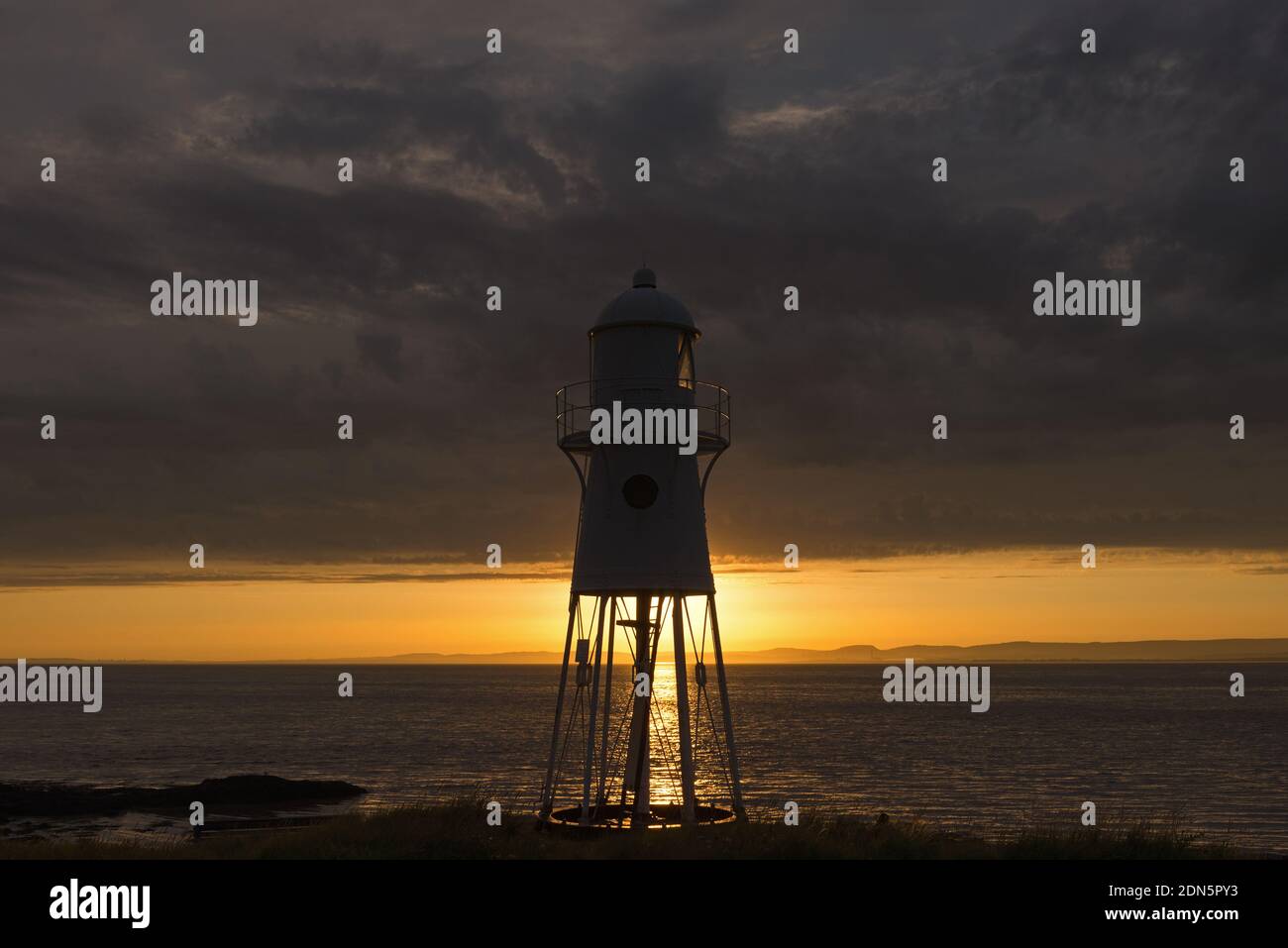 A sunset picture featuring Black Nore Lighthouse overlooking the ...