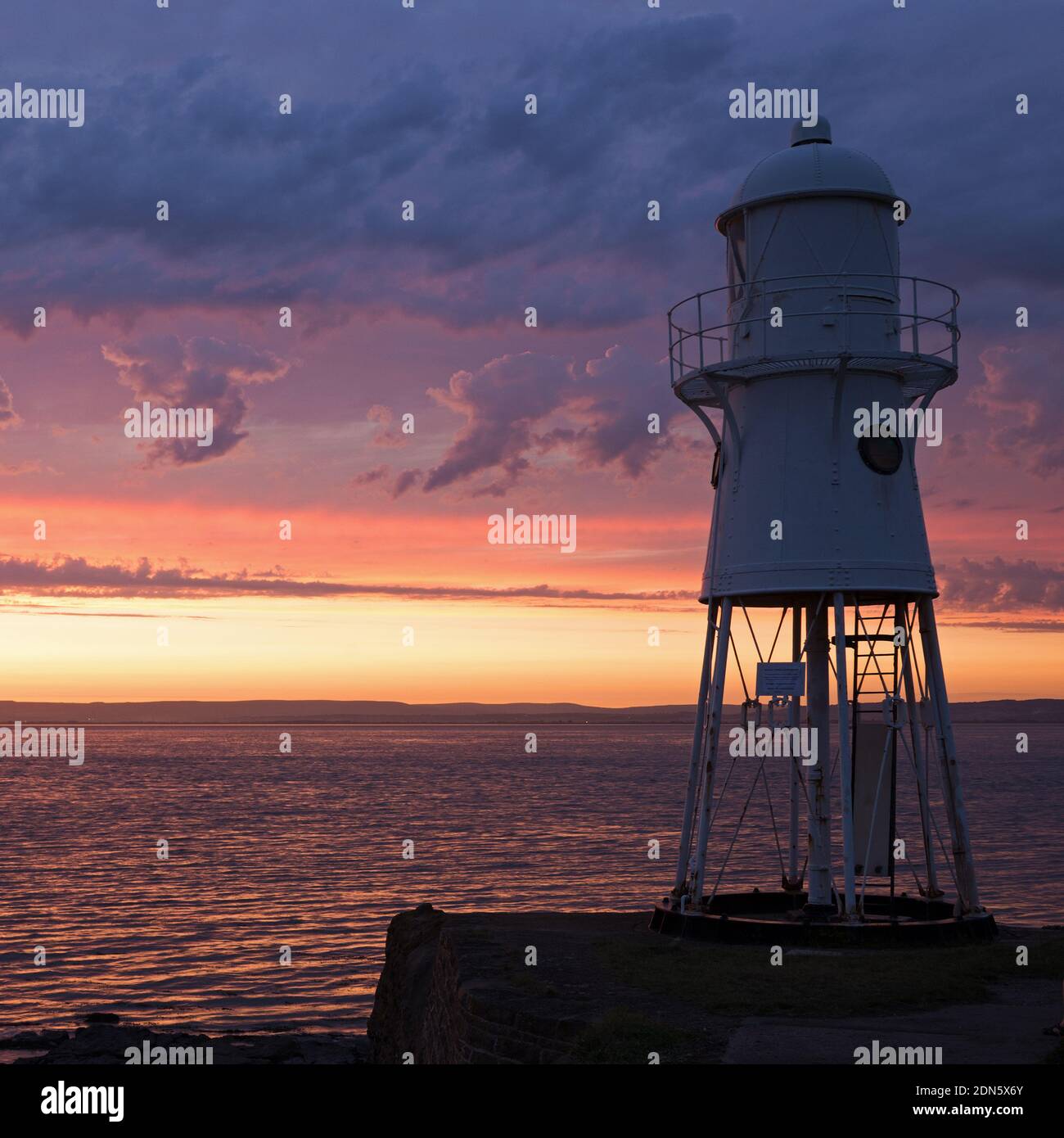 A sunset picture featuring Black Nore Lighthouse overlooking the ...