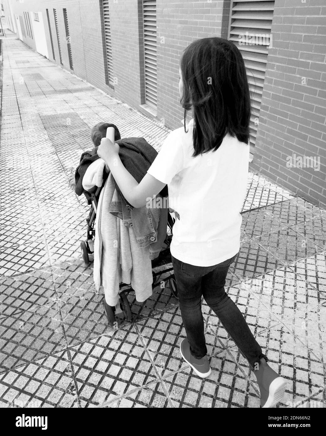 Girl pushing baby carriage Black and White Stock Photos & Images - Alamy
