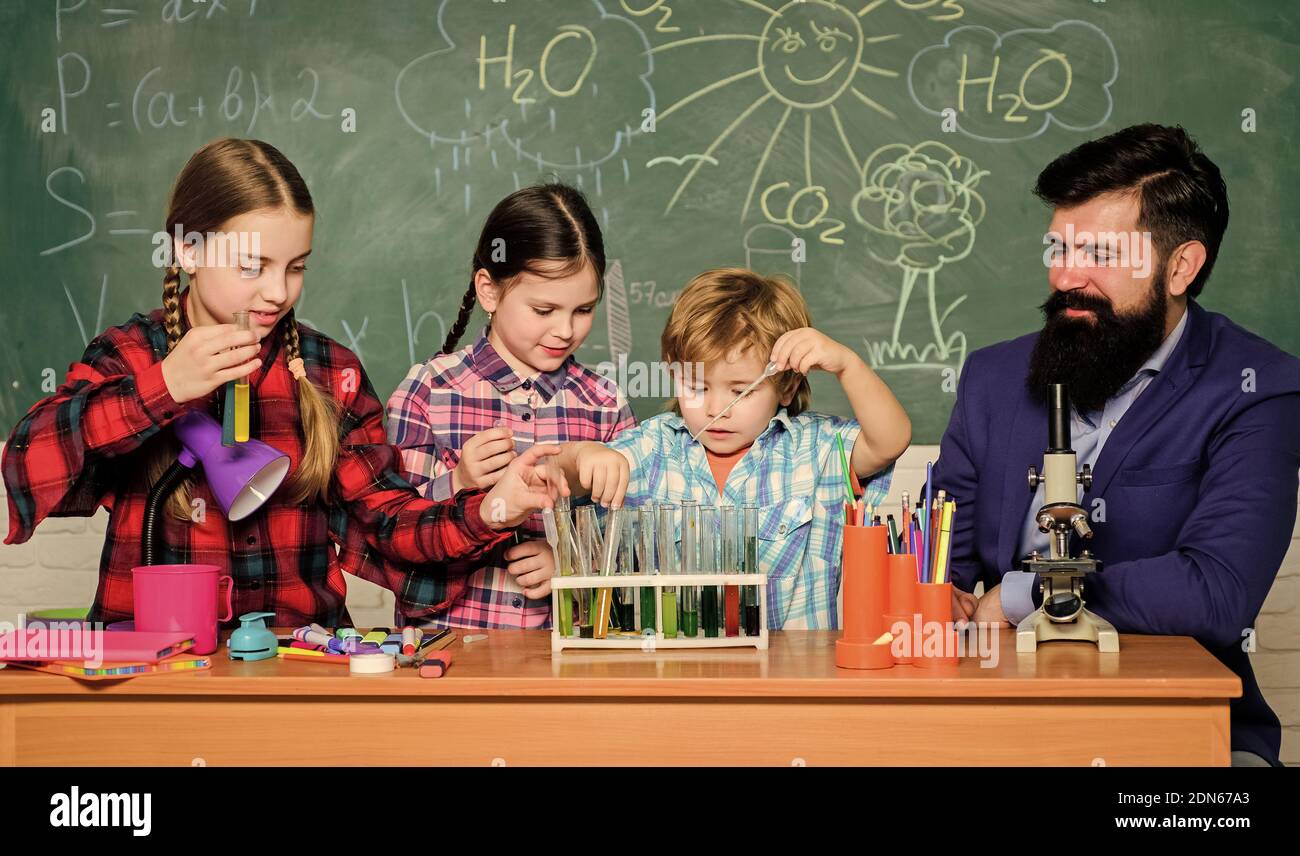 School club education. Teacher and pupils test tubes in classroom ...