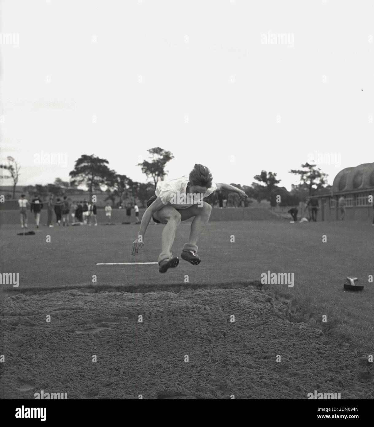 1960s, historical, front view of a young man, outside in a sports field ...