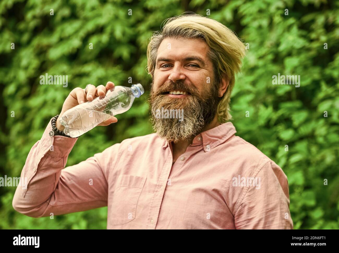 Soda water. Water balance. Man bearded tourist drinking water plastic ...
