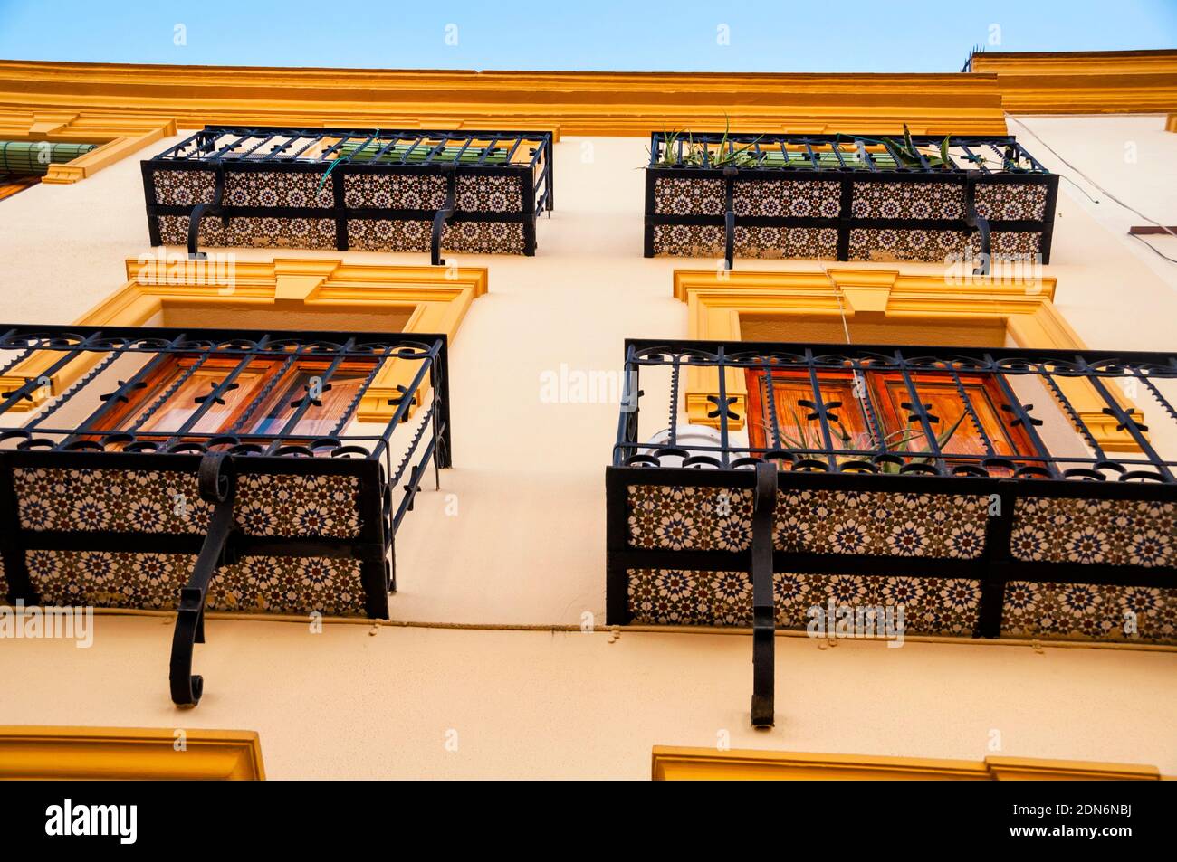 Iron balconies in sunny southern Spain showcasing Moorish tile details ...
