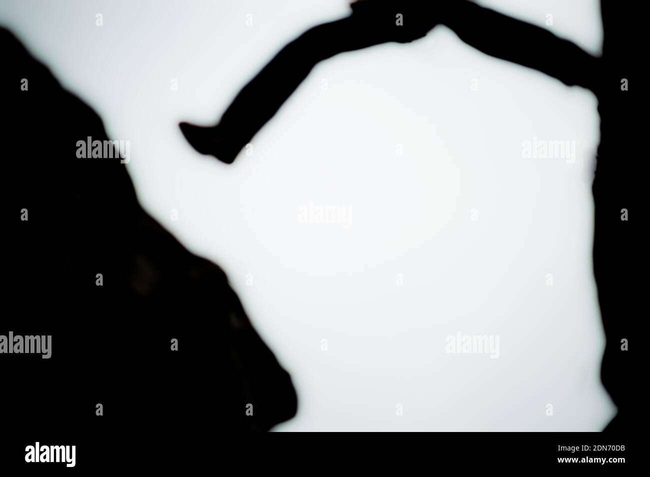 silhouette of a leaping man between two rocks Stock Photo - Alamy