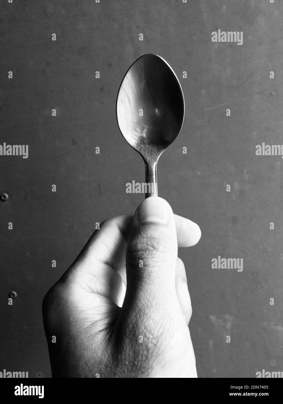 Holding spoon Black and White Stock Photos & Images - Alamy