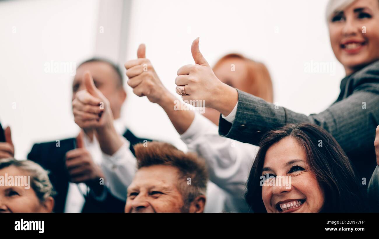 close up. image of business people showing thumbs up Stock Photo - Alamy
