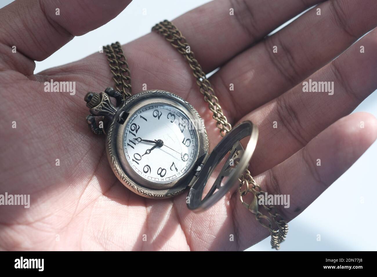 Hand holding watch on chain hi-res stock photography and images - Alamy