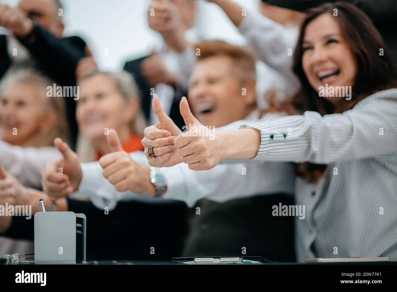 close up. image of business people showing thumbs up Stock Photo - Alamy