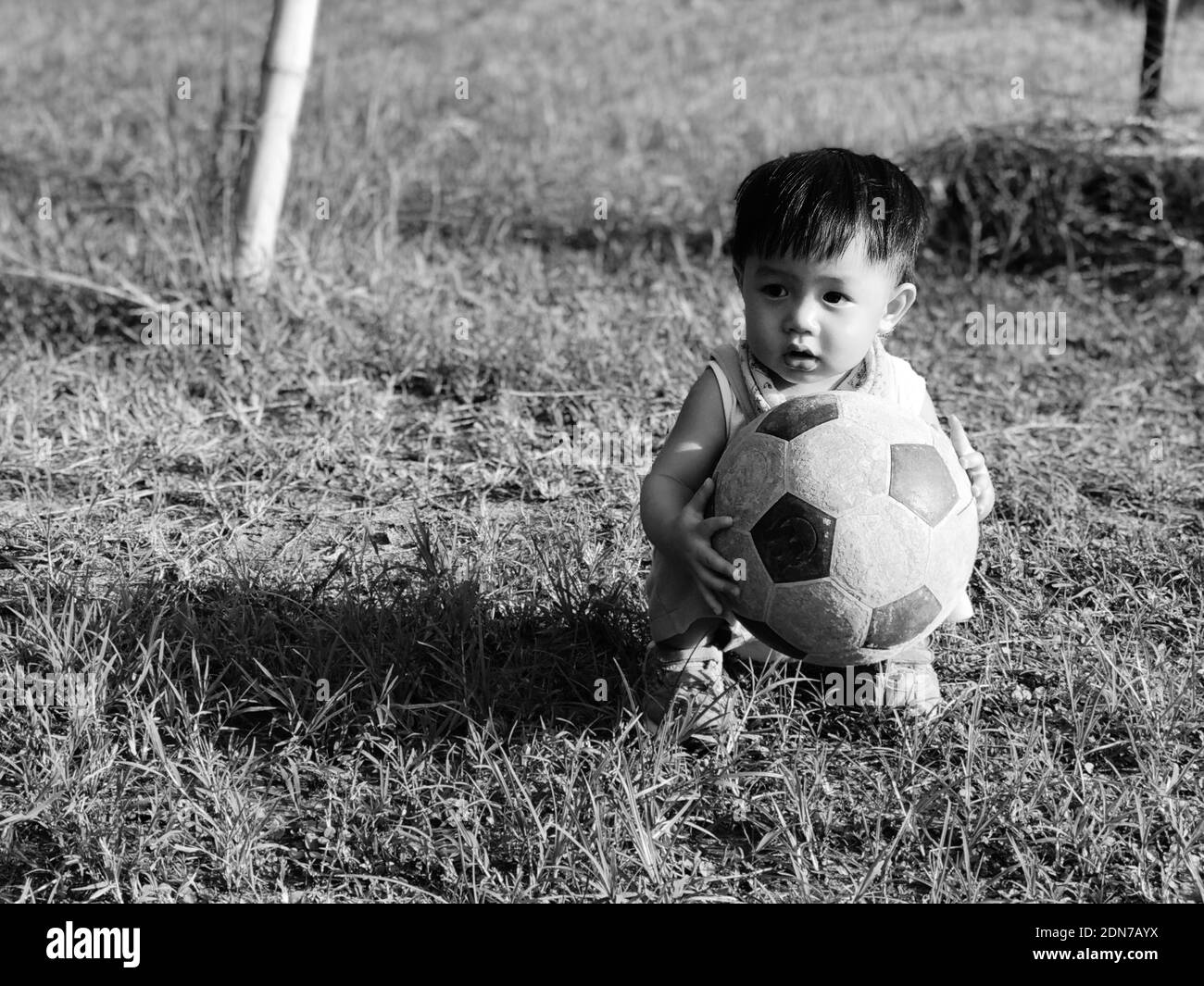 Boys playing football Black and White Stock Photos & Images - Alamy