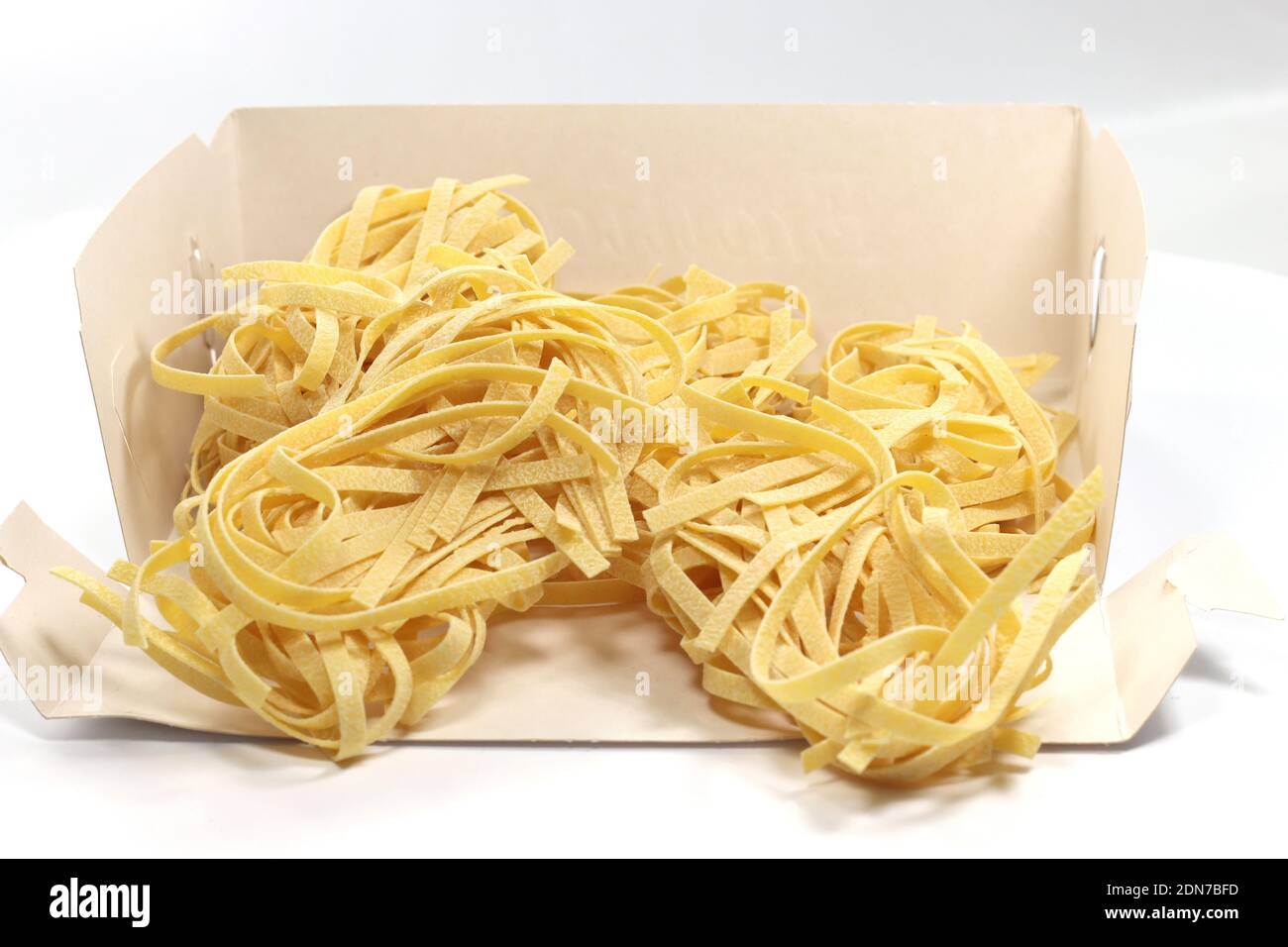 A closeup shot of raw noodles in a white card box Stock Photo - Alamy