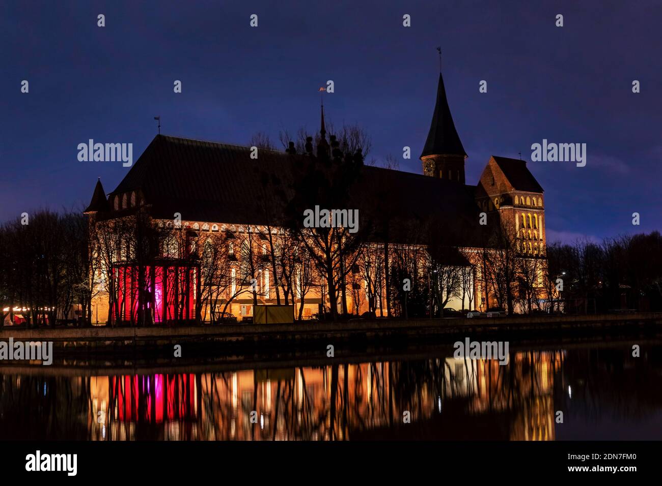 Brick Gothic style Cathedral at night, side view from the river ...