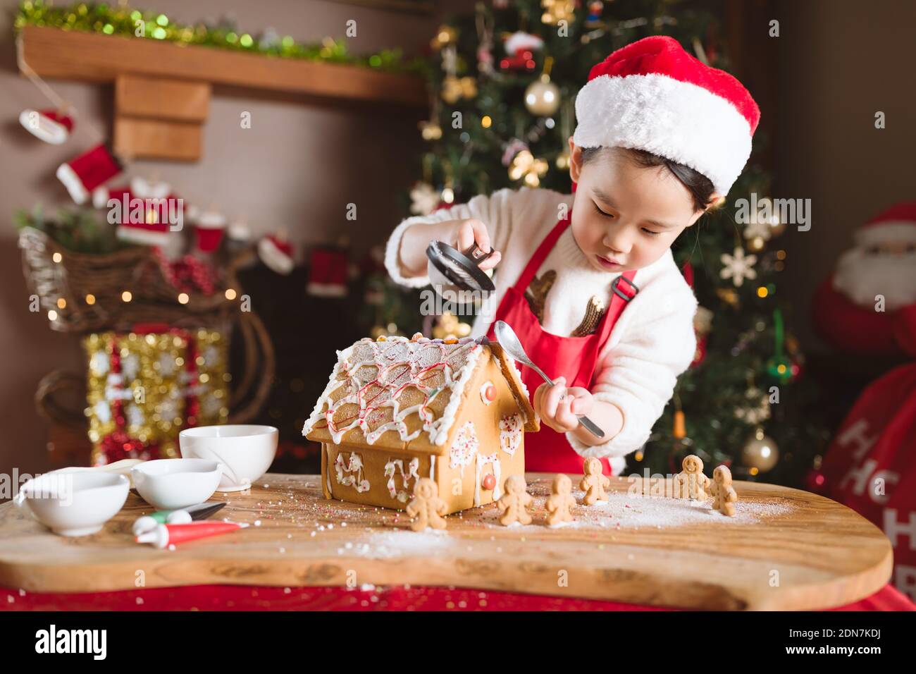 young girl making gingerbread house at home Stock Photo - Alamy