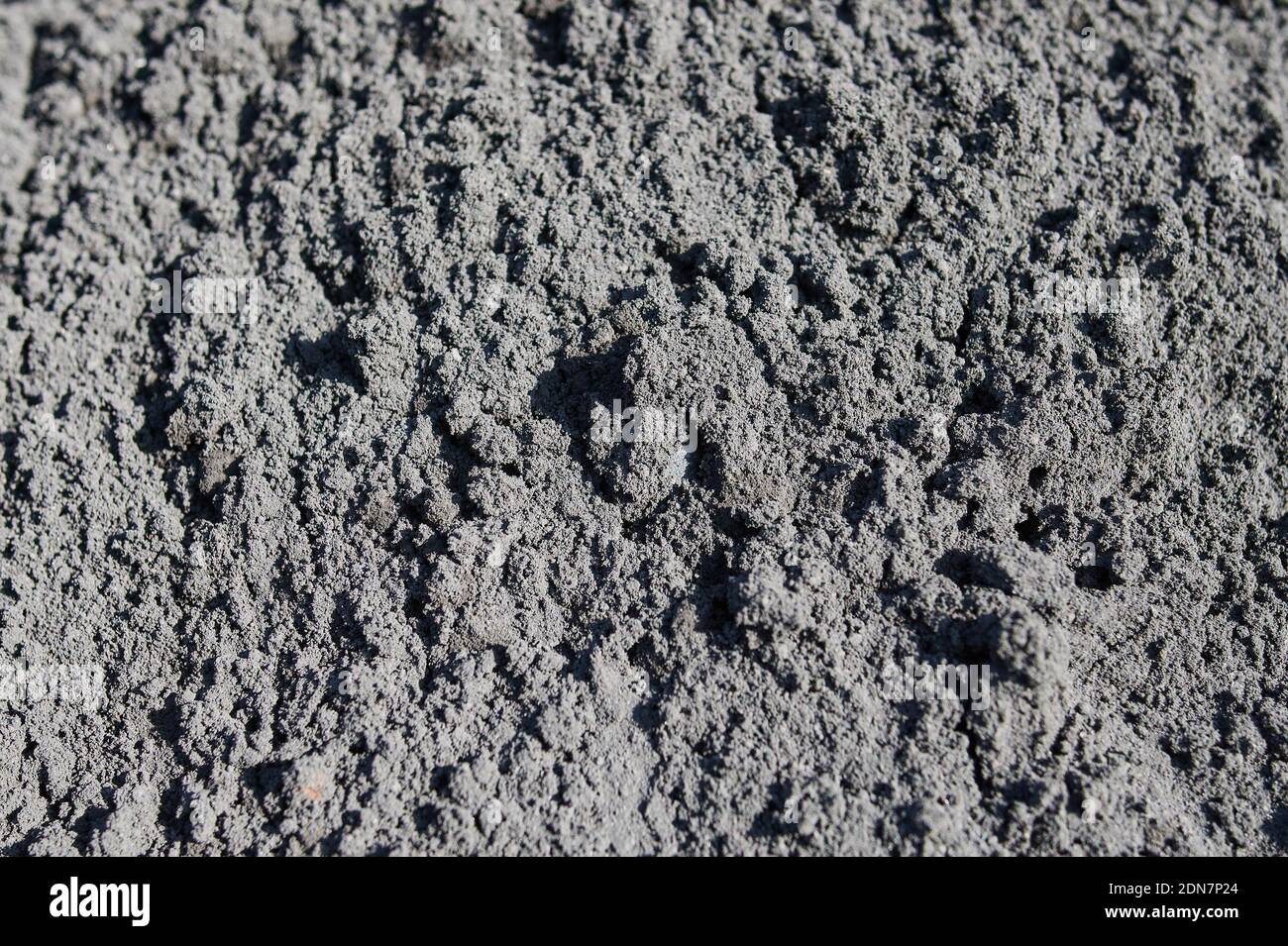 wet fresh lumps of concrete with gate polls and a spayed in the ...